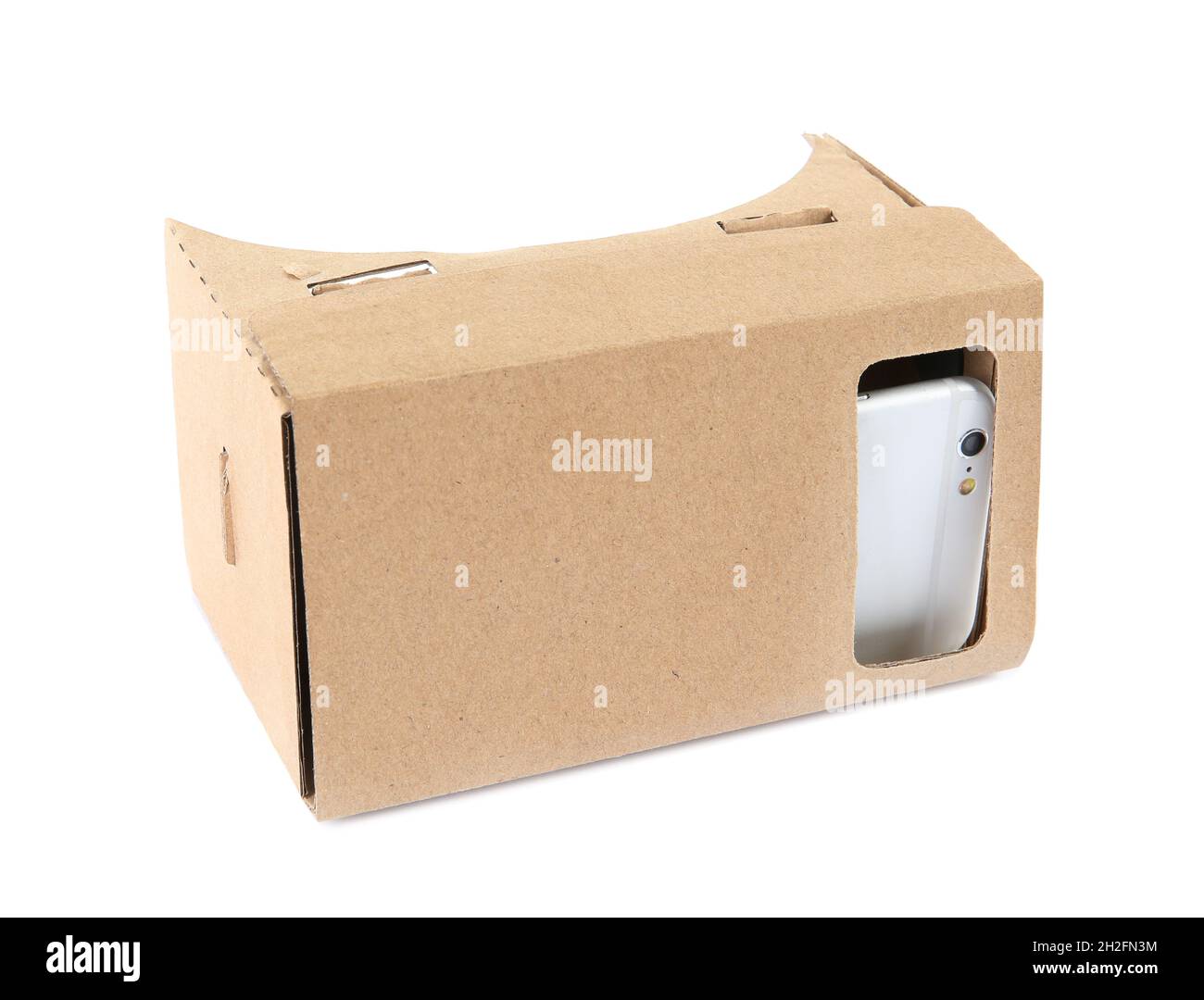 Cardboard virtual reality headset and smartphone on white background ...