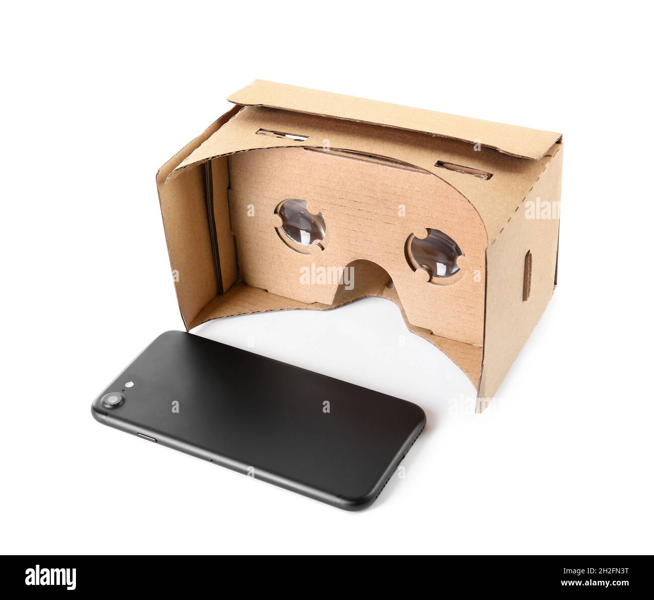 Cardboard virtual reality headset and smartphone on white background ...