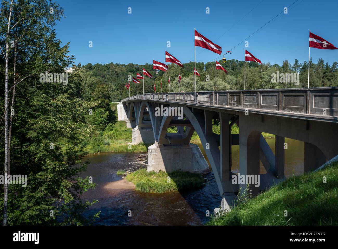 Bridge over Gauja River with Latvian Flags - Sigulda, Latvia Stock ...