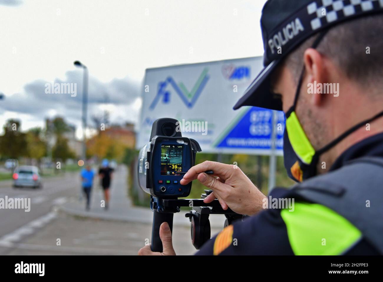 An officer observes the speed radar at a police checkpoint.The Local ...