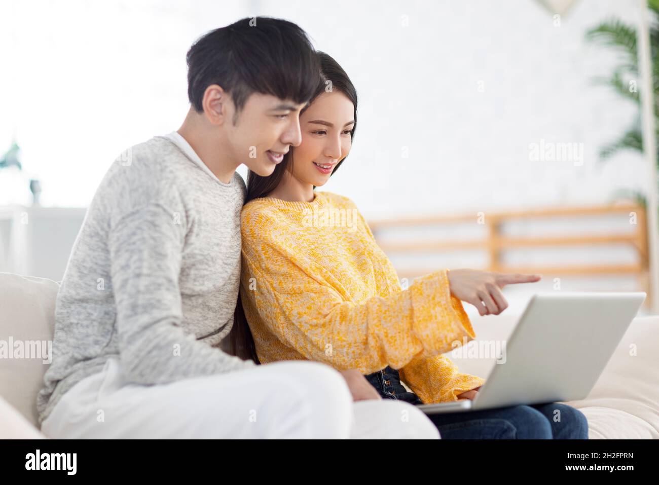 Happy couple laptop computer winter hi-res stock photography and images ...