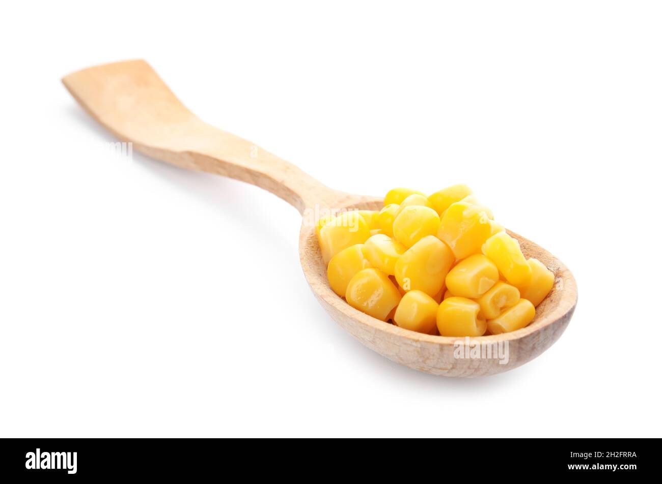 Wooden spoon with corn kernels on white background Stock Photo - Alamy