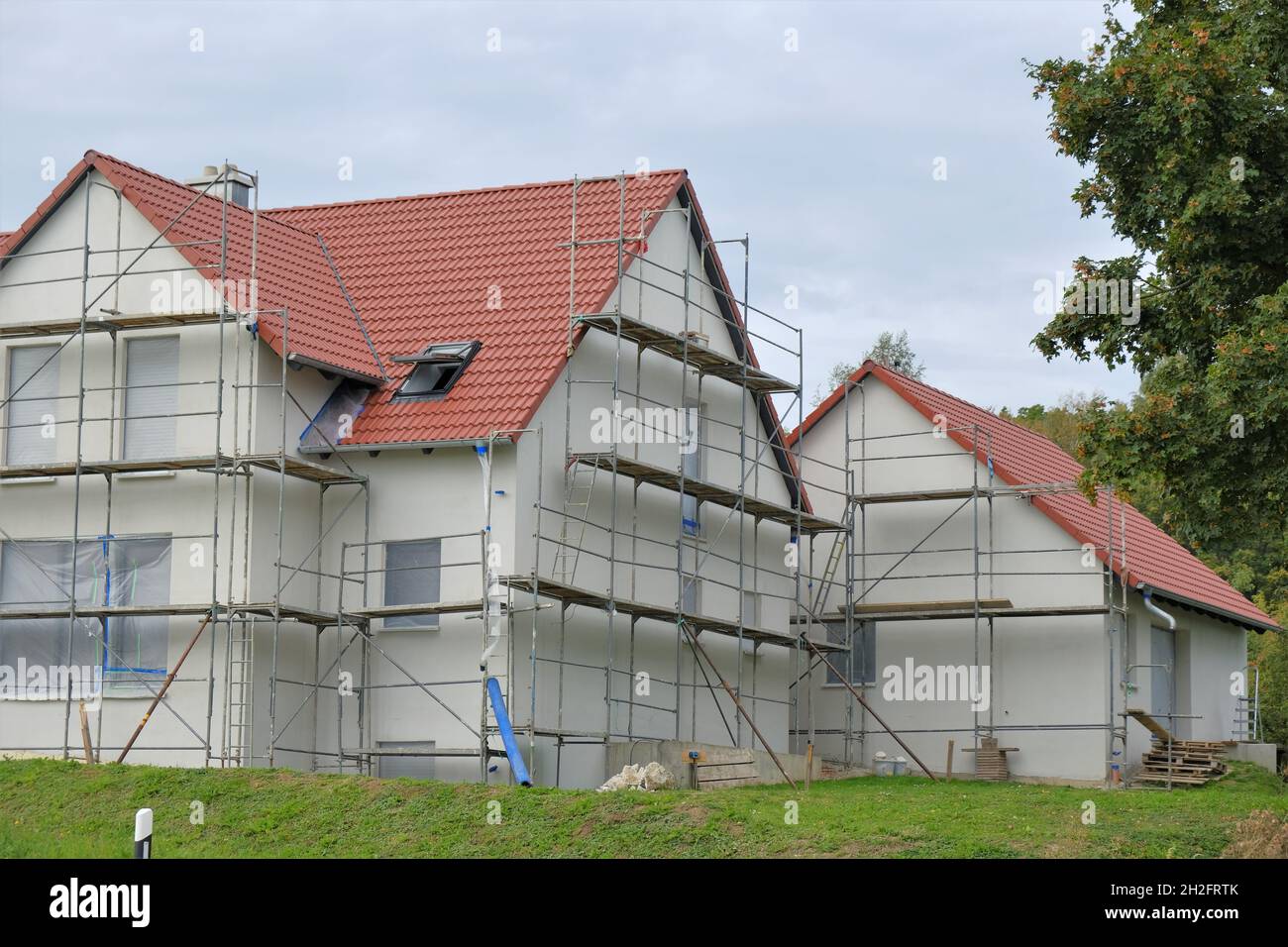 Home construction.Scaffolding . New house with roof in scaffolding ...