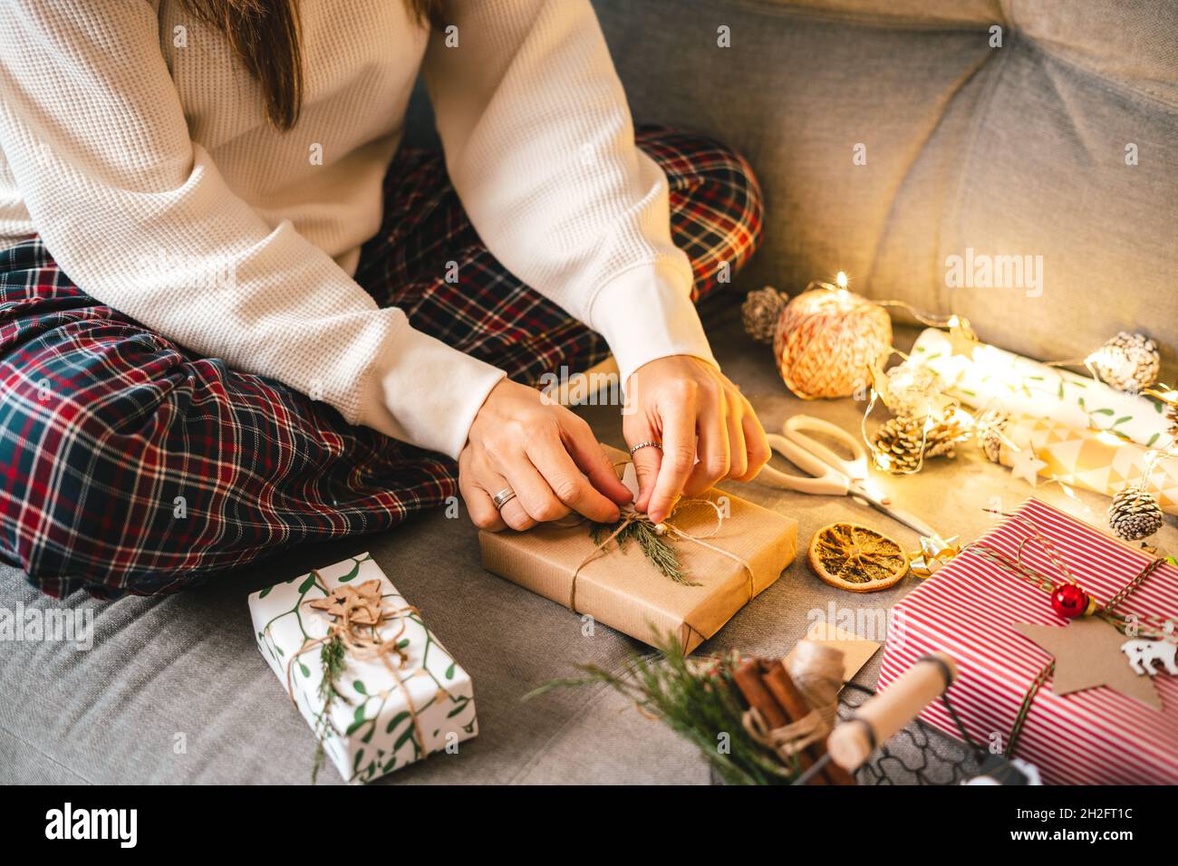 Woman s hands wrapping Christmas gift boxes, close up. Cropped female ...