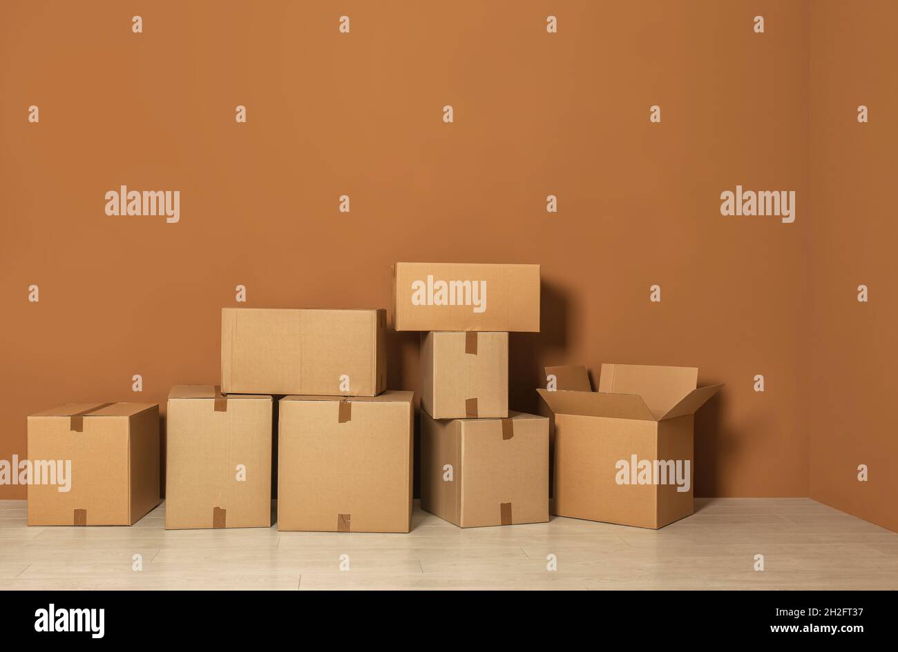 Cardboard boxes on floor indoors Stock Photo - Alamy