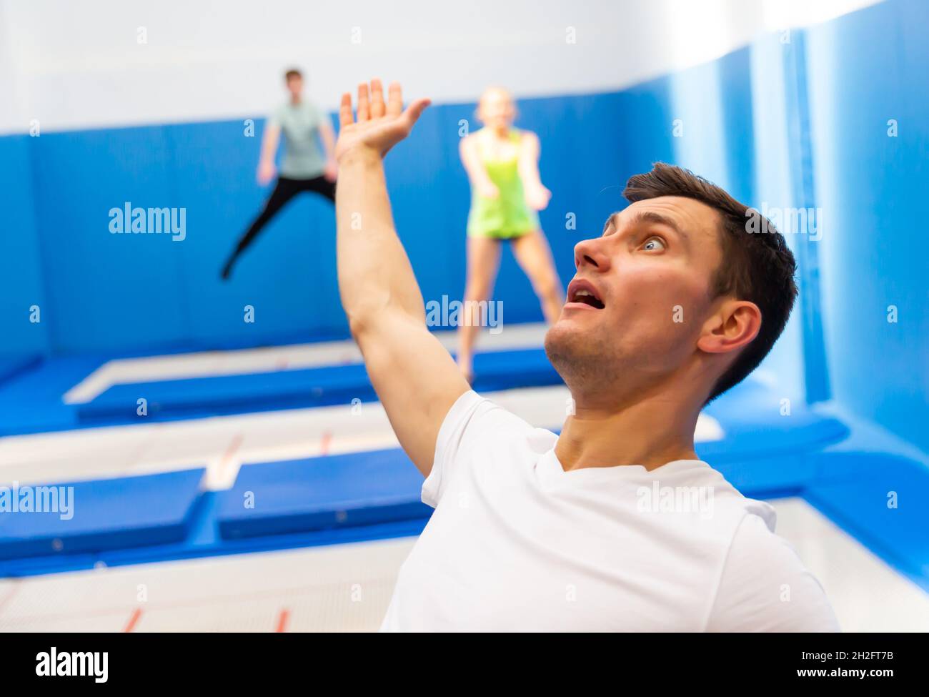 Portrait of excited man jumping on trampoline Stock Photo - Alamy