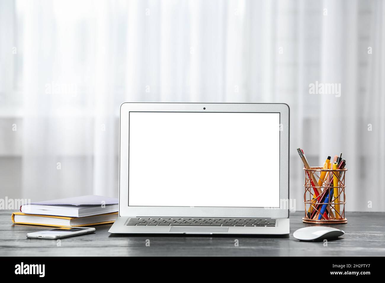Laptop on desk near window in home office. Comfortable workplace Stock ...