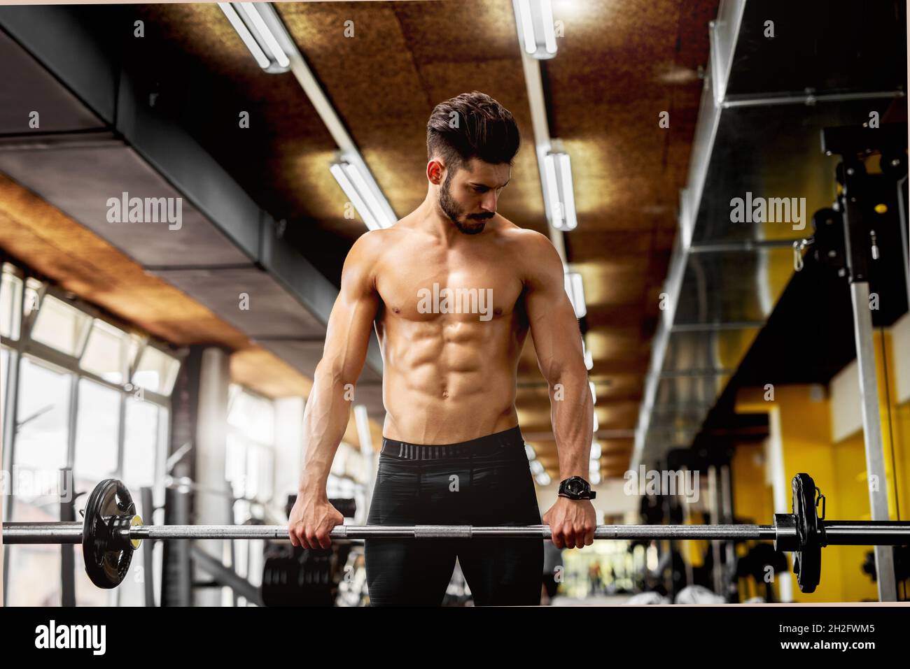 Handsome muscular man working out at gym Stock Photo - Alamy