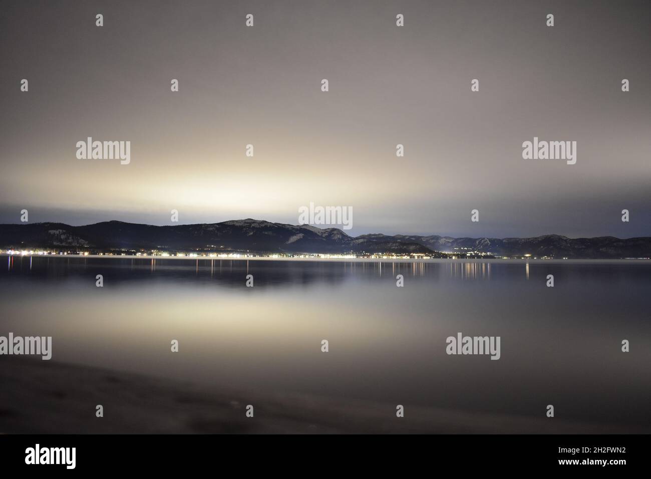 Landscape of Lake Tahoe with long exposure under a cloudy sky at night ...