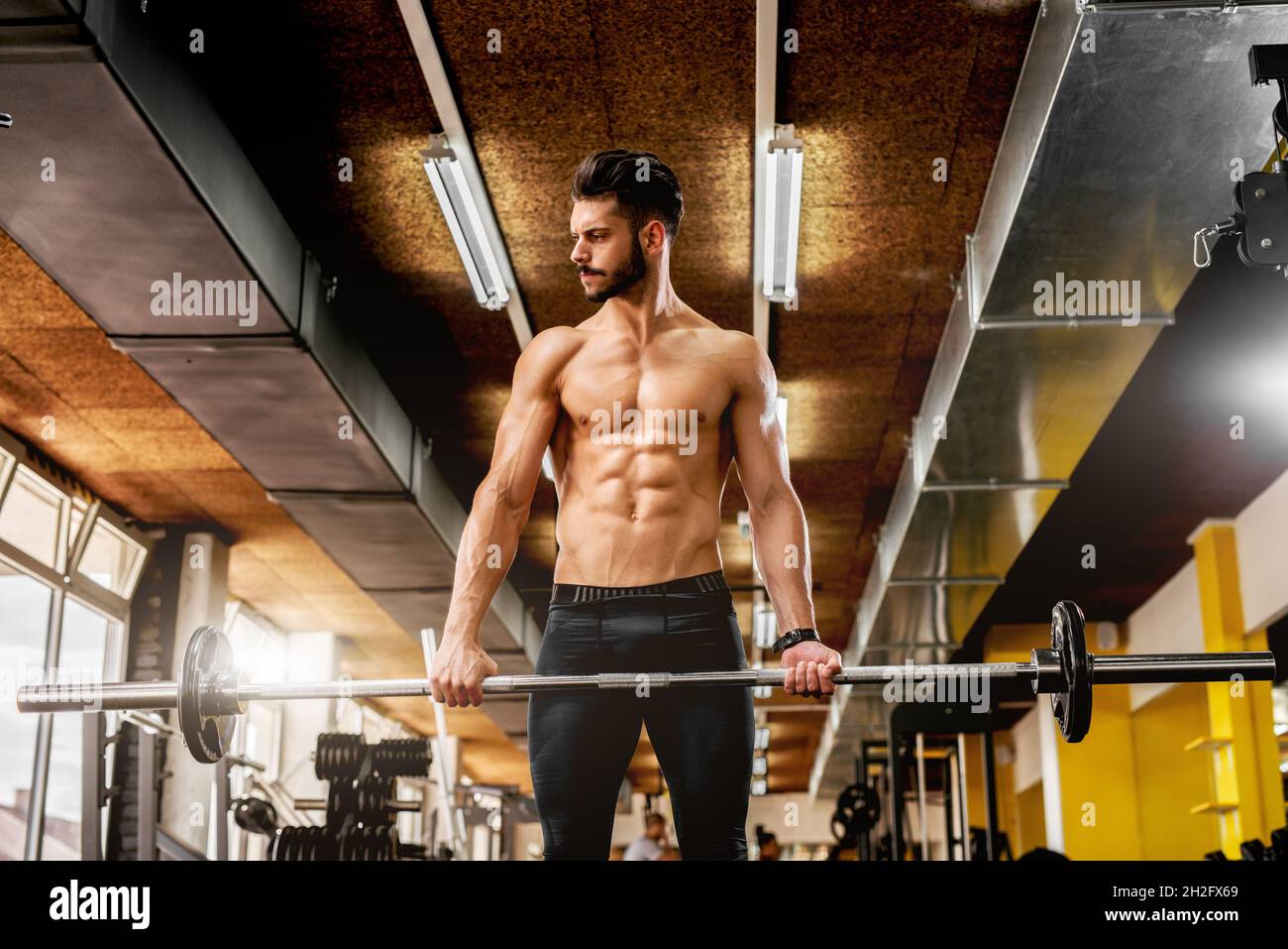 Handsome muscular man working out at gym Stock Photo - Alamy
