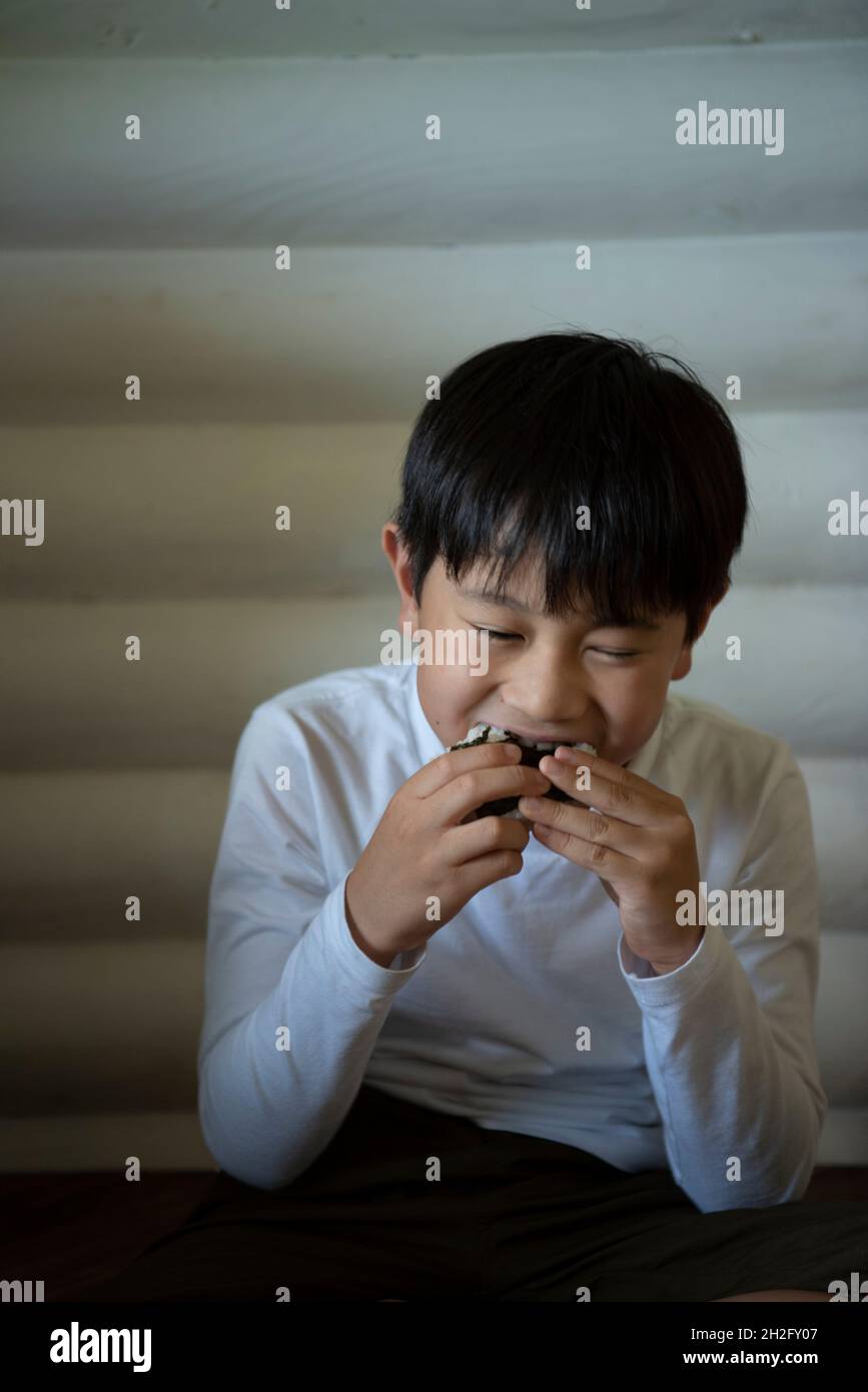 Child Eating Rice Ball Stock Photo - Alamy