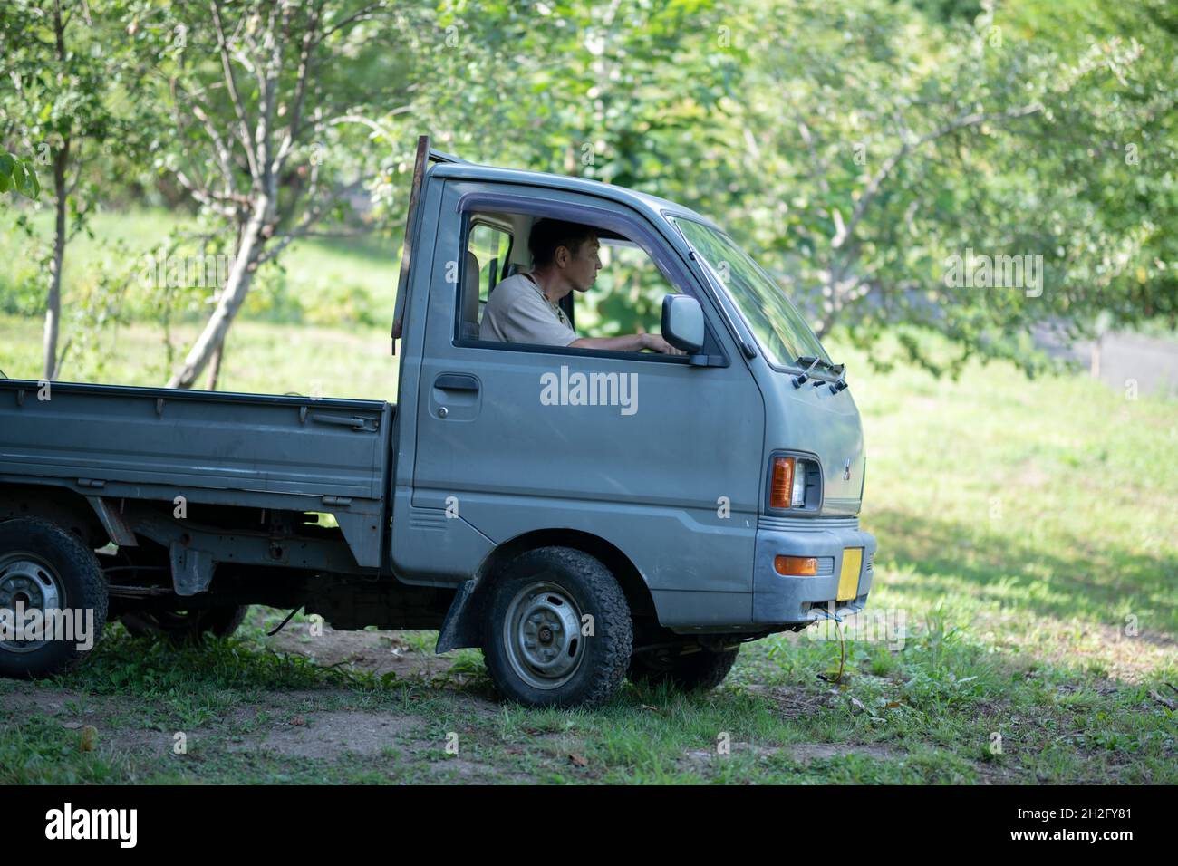 Man Driving Small Truck Stock Photo - Alamy