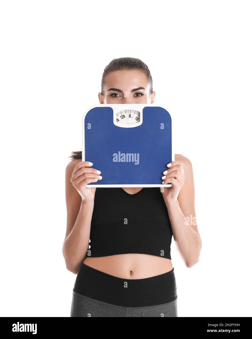 Happy young woman with scales on white background. Weight loss ...