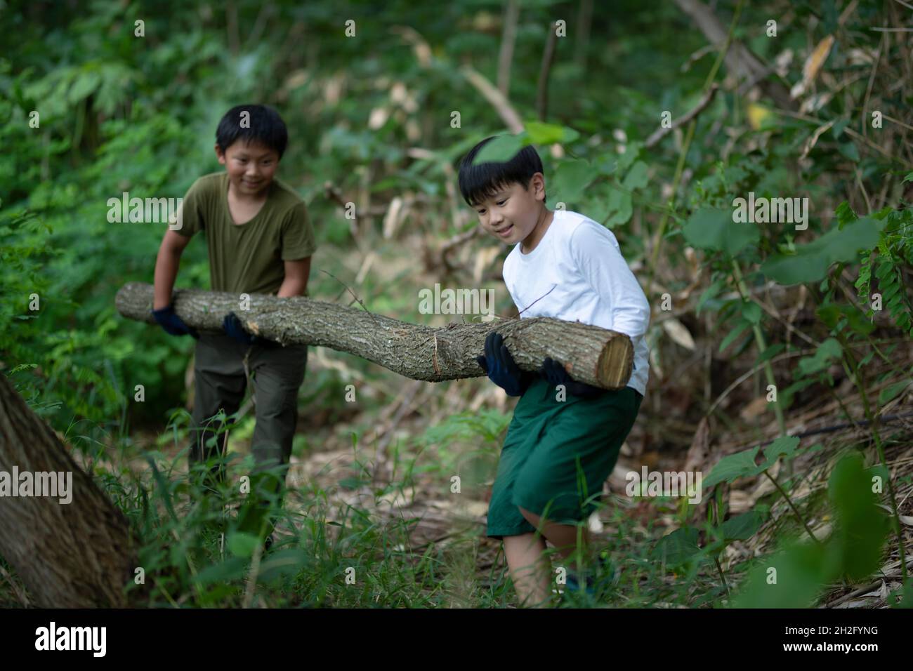 Children Carrying Log Stock Photo - Alamy