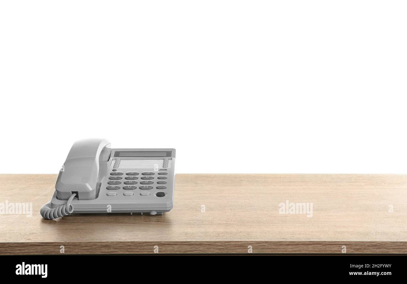 Telephone on wooden table against white background Stock Photo - Alamy