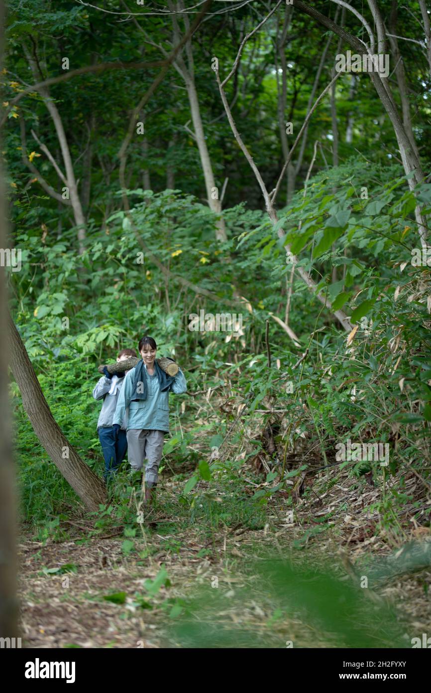 Women Carrying Log Stock Photo - Alamy