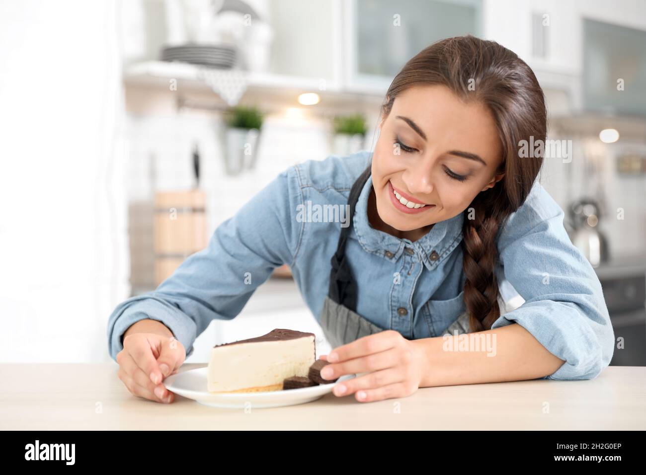 Professional female chef presenting dessert on table in kitchen Stock ...