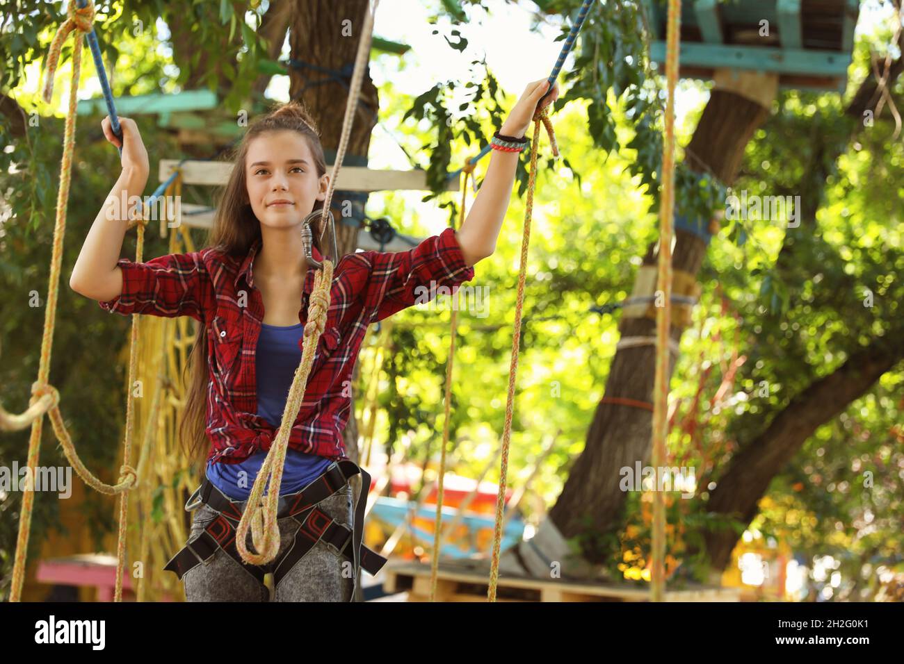 Teenage girl climbing in adventure park. Summer camp Stock Photo - Alamy
