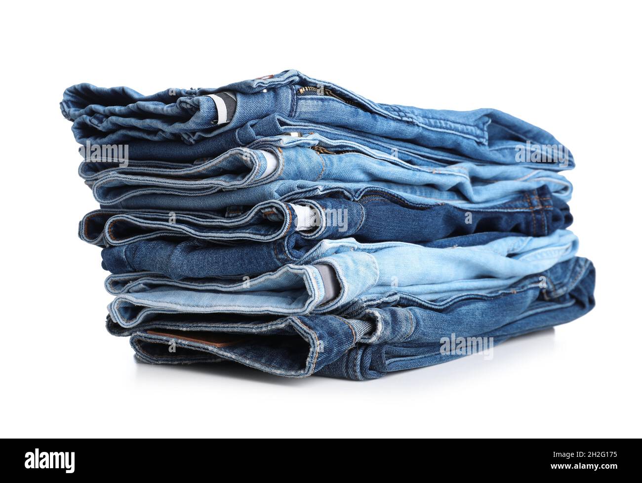 Stack of stylish jeans on white background Stock Photo - Alamy