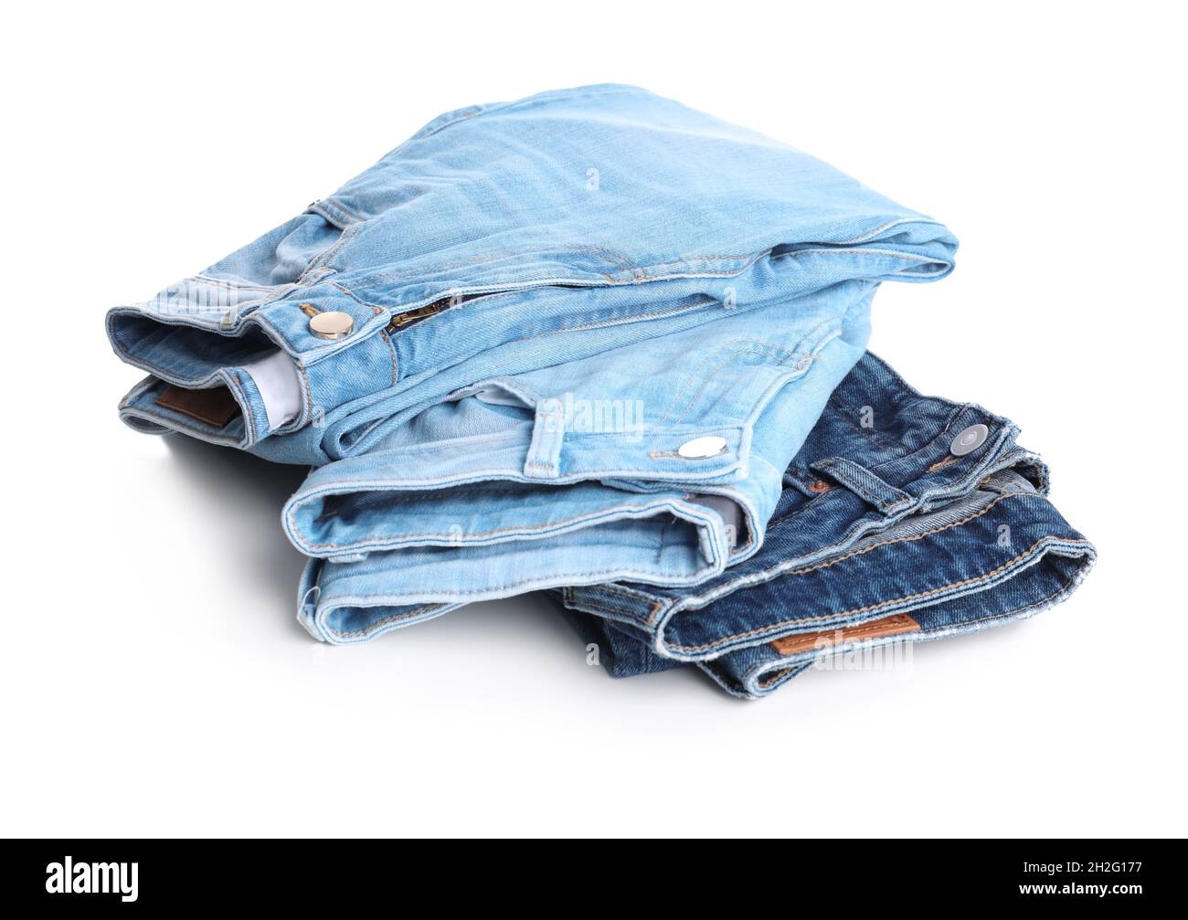 Stack of stylish jeans on white background Stock Photo - Alamy