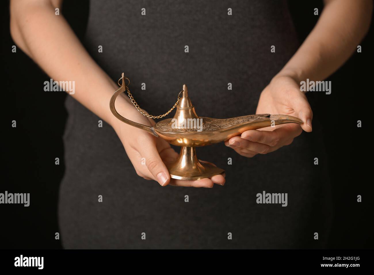 Woman rubbing magical Aladdin lamp, closeup Stock Photo - Alamy