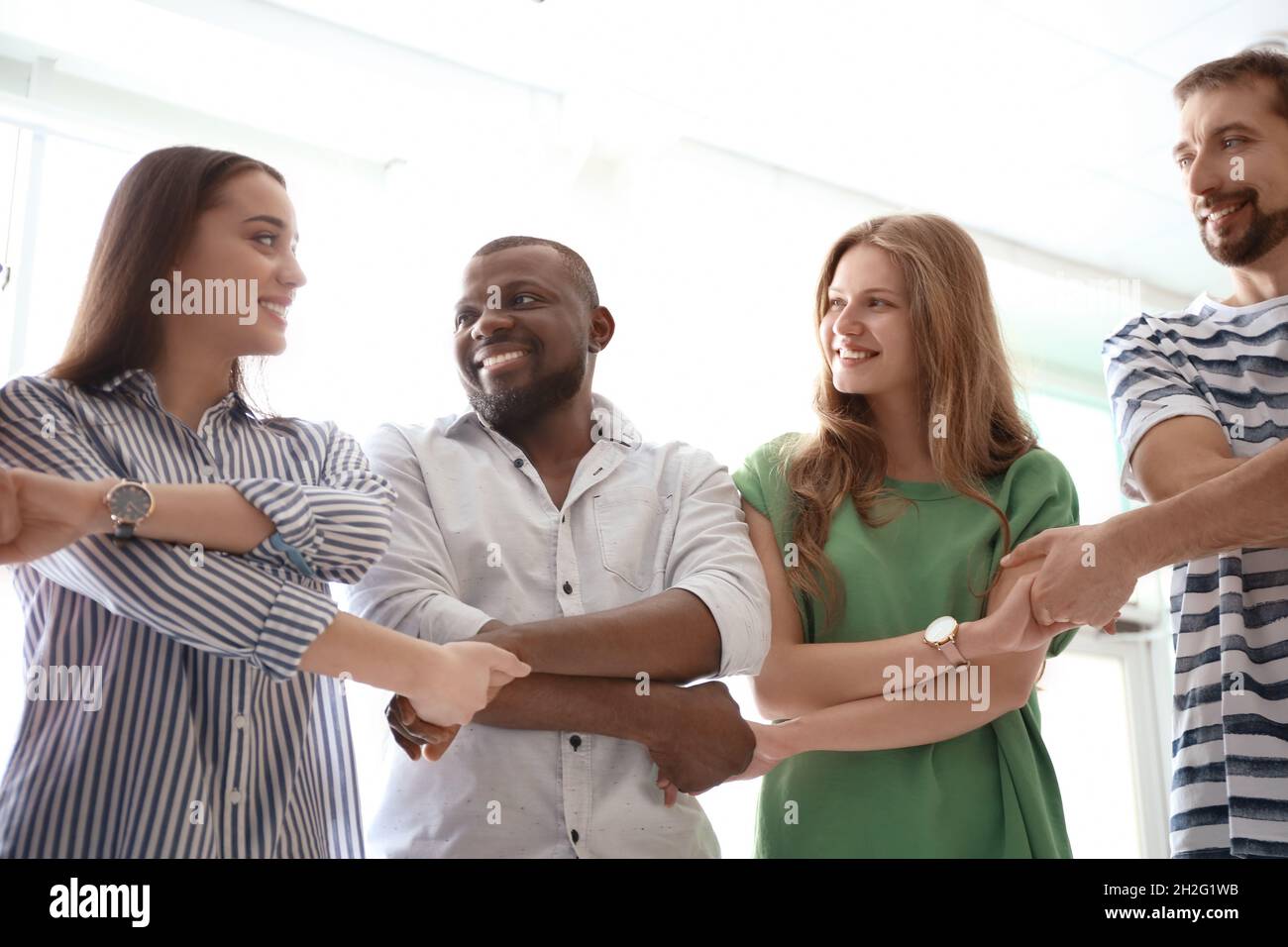 People holding hands on light background. Unity concept Stock Photo - Alamy