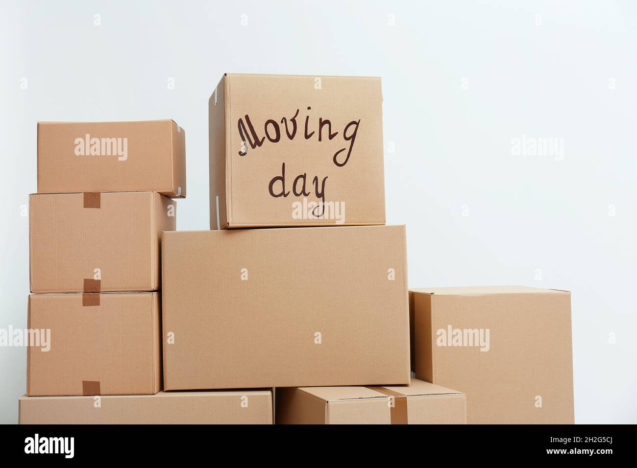 Pile of moving boxes on white background Stock Photo - Alamy