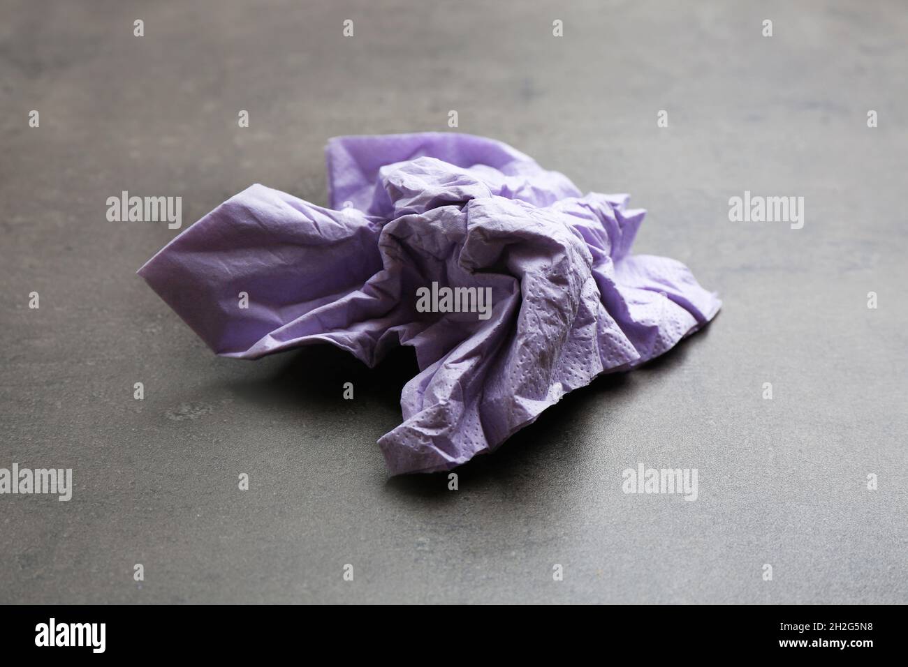 Crumpled paper napkin on grey background. Personal hygiene Stock Photo ...