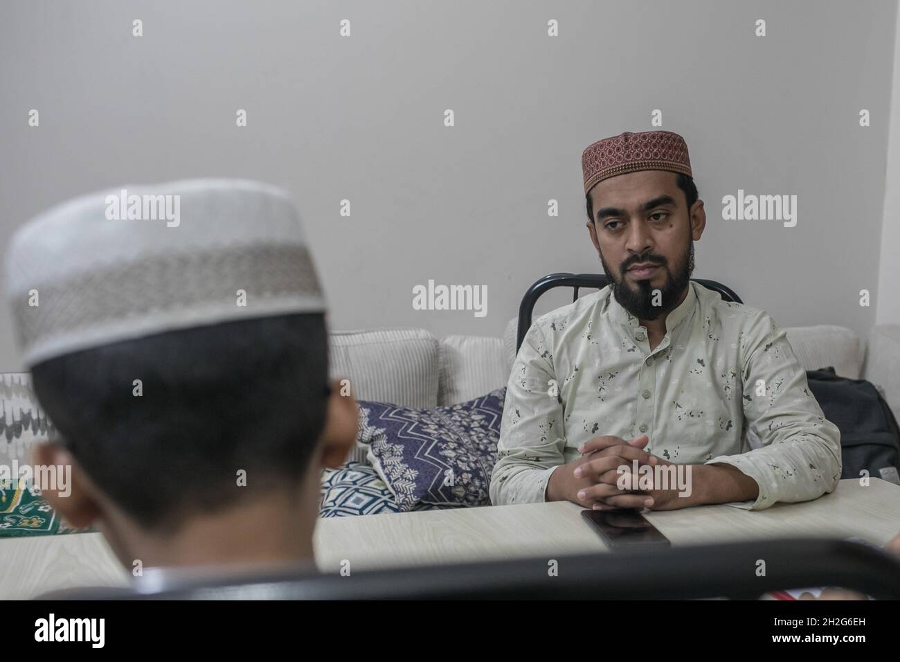 A Muslim man seen teaching a child how to read the Holy Quran in a ...