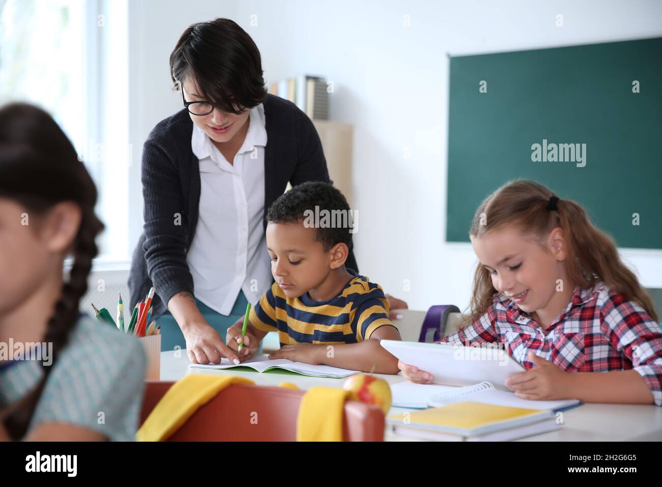 Child helping friend work hi-res stock photography and images - Alamy