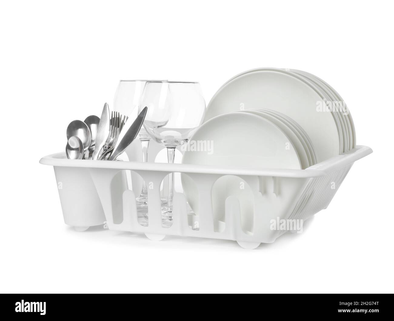 Rack with clean tableware and utensils on white background. Washing ...