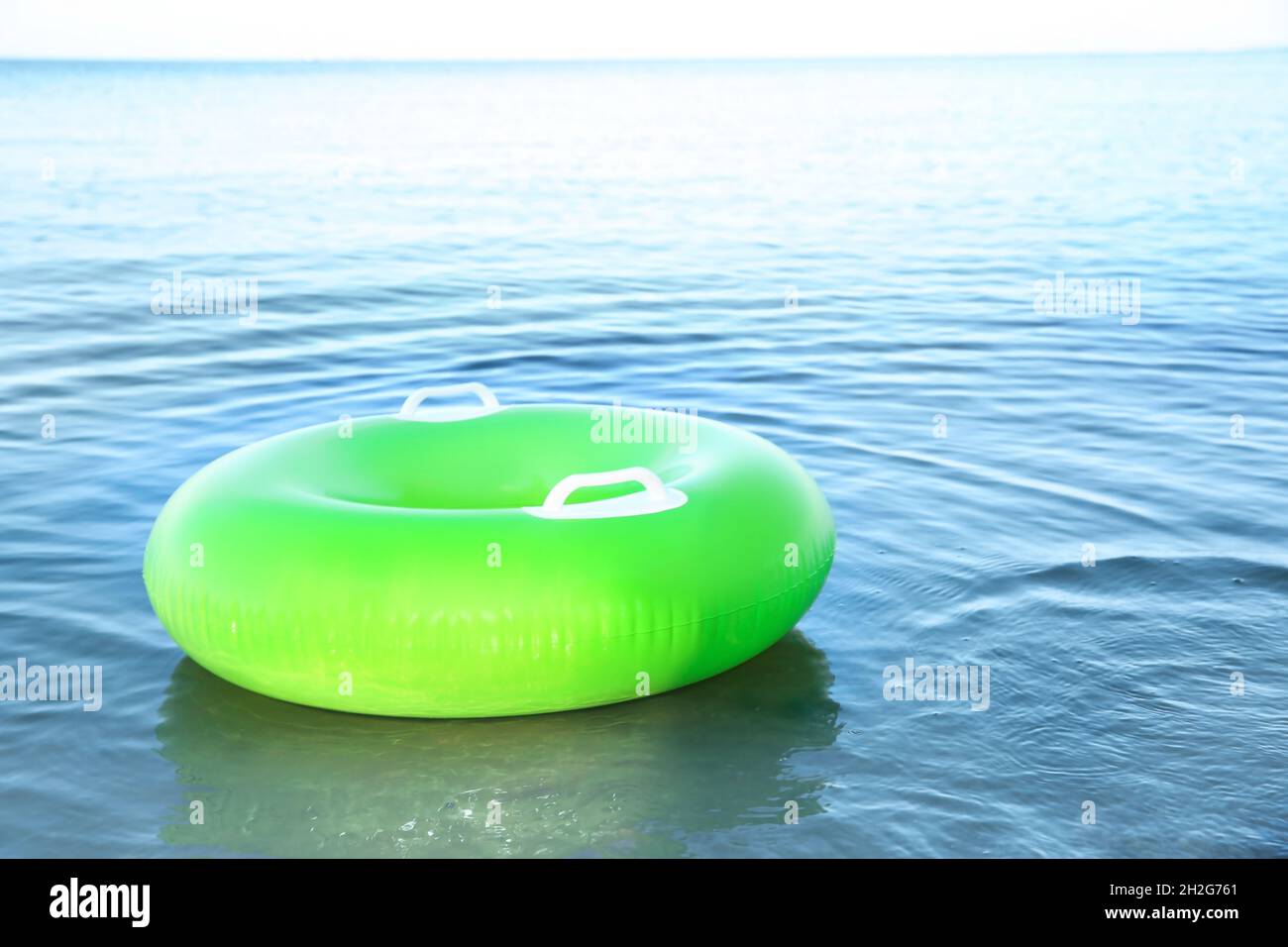 Inflatable ring floating on sea water. Summer vacation Stock Photo - Alamy