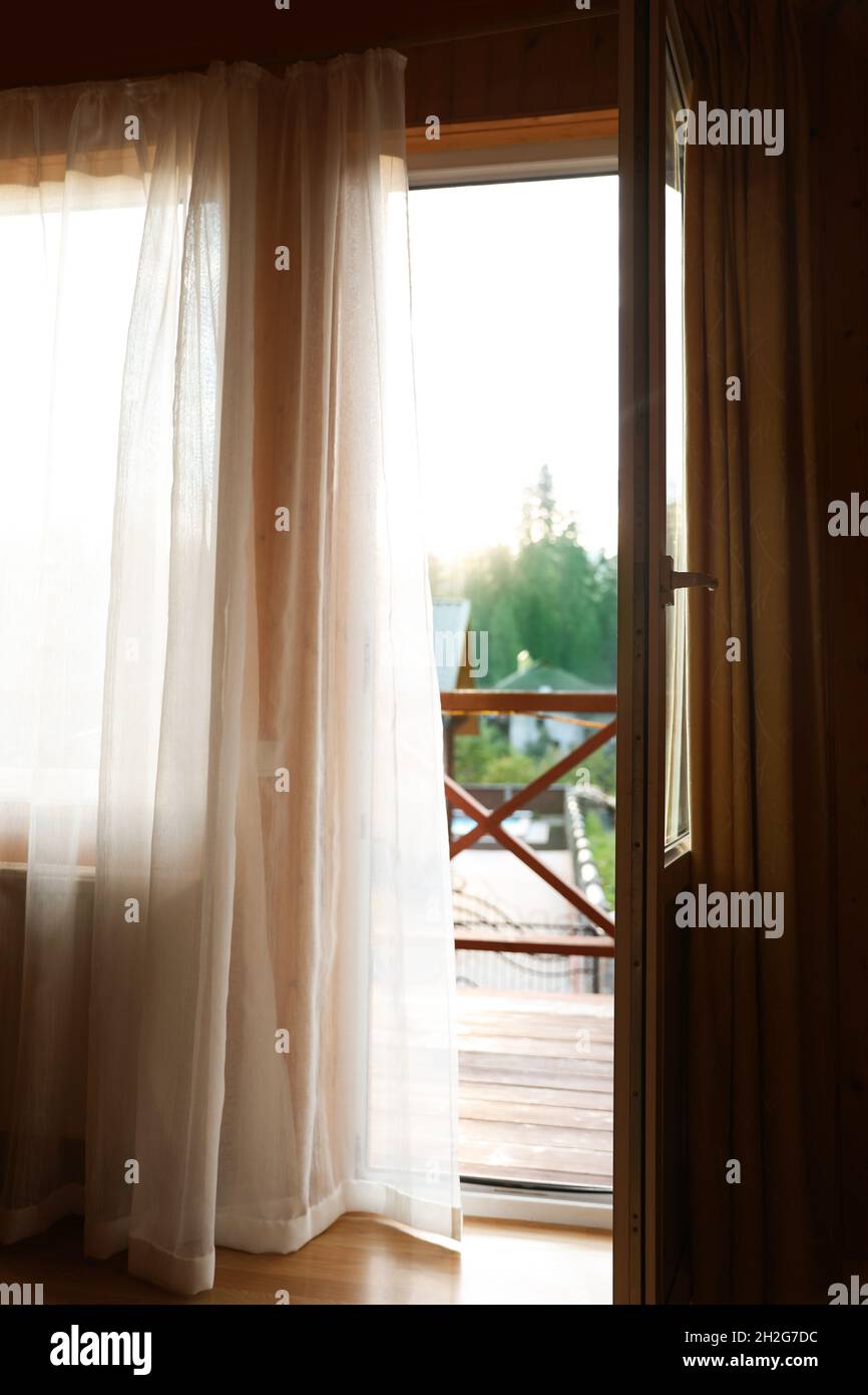 Open balcony door with curtain in apartment Stock Photo - Alamy