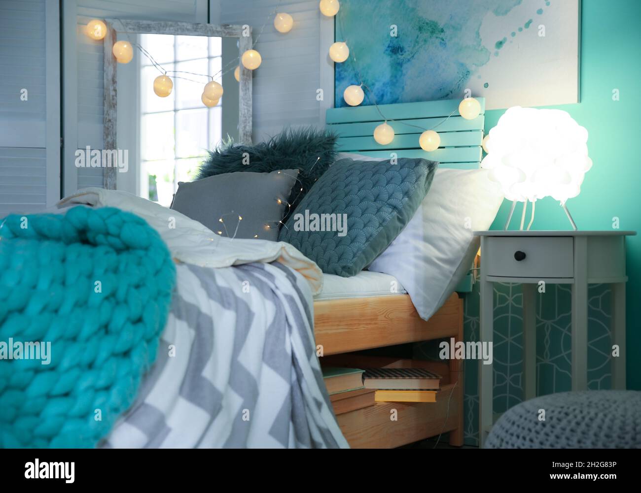 Cozy room interior with comfortable bed Stock Photo - Alamy
