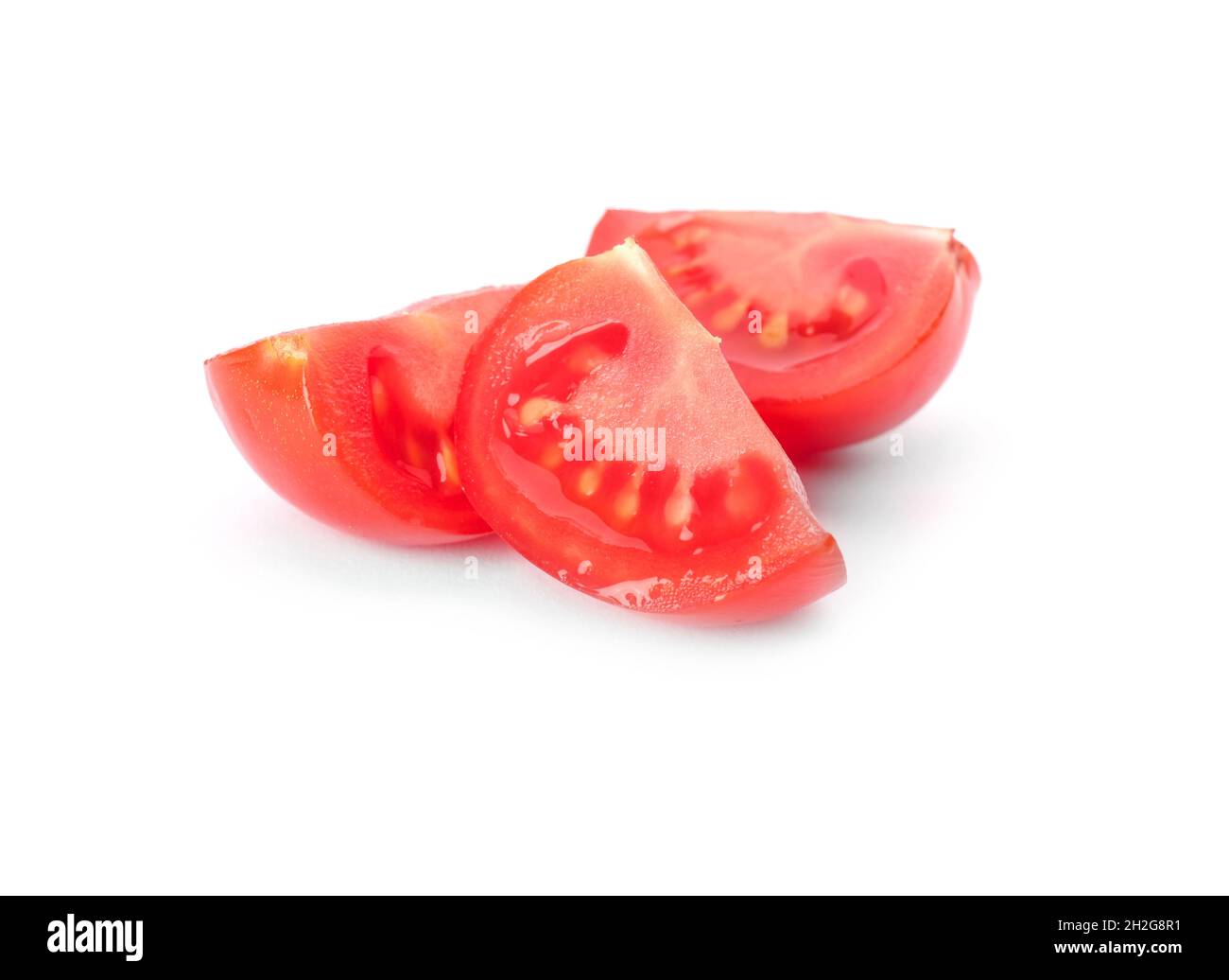 Cut red tomato on white background Stock Photo - Alamy