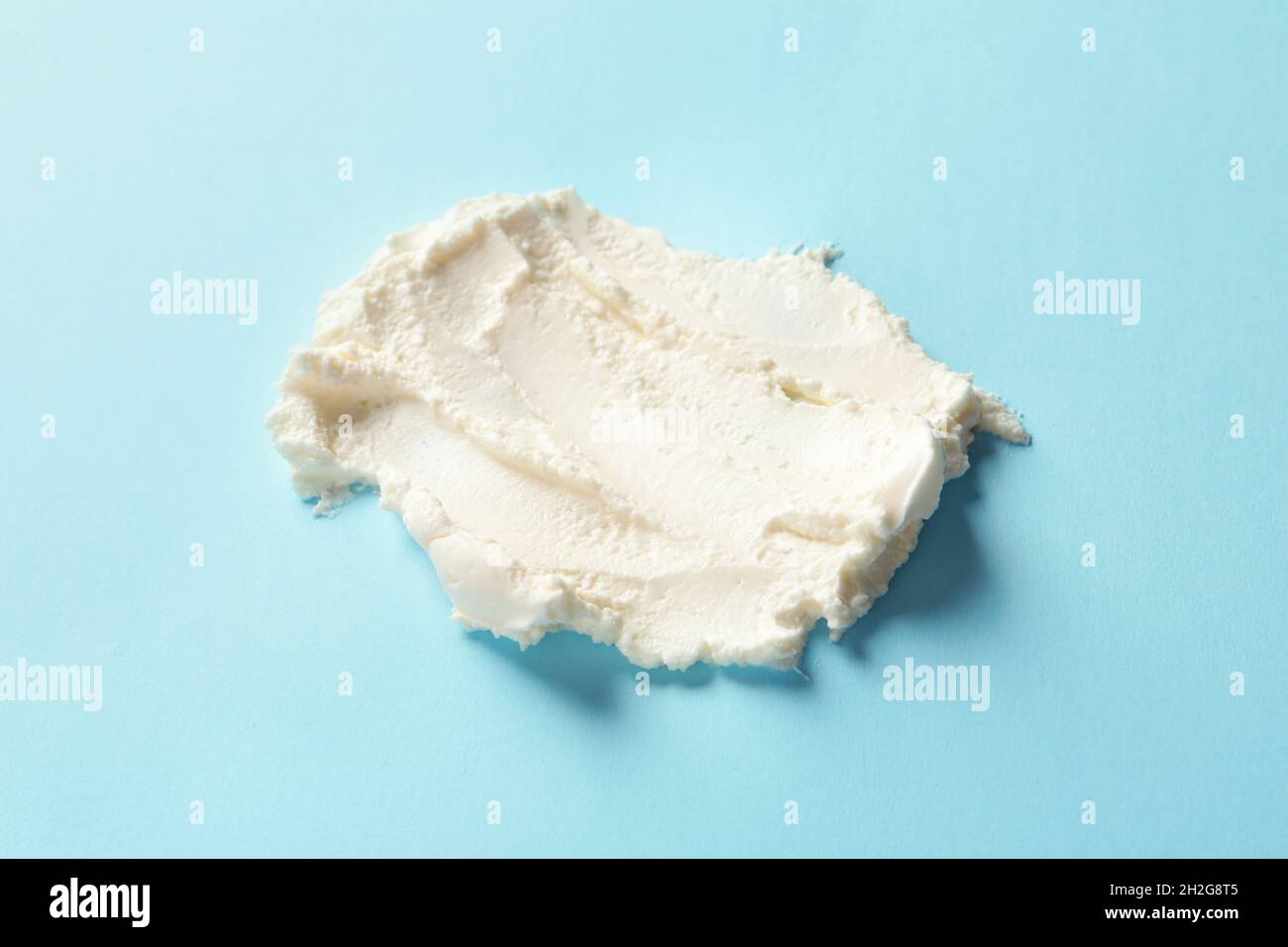 Smear of tasty cream cheese on color background Stock Photo - Alamy