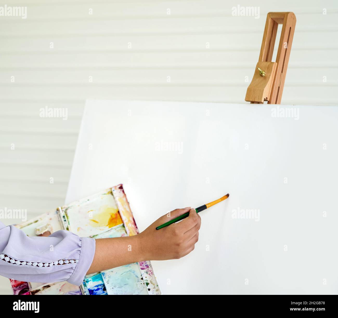 Closeup hand drawing a white board in watercolor painting art classes ...