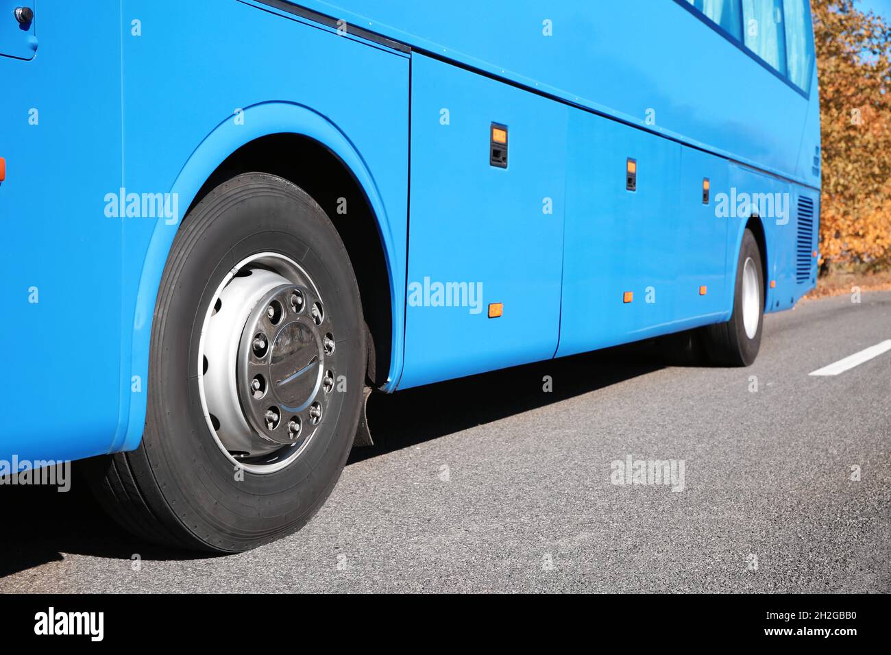 Modern blue bus on road, focus on wheel. Passenger transportation Stock ...