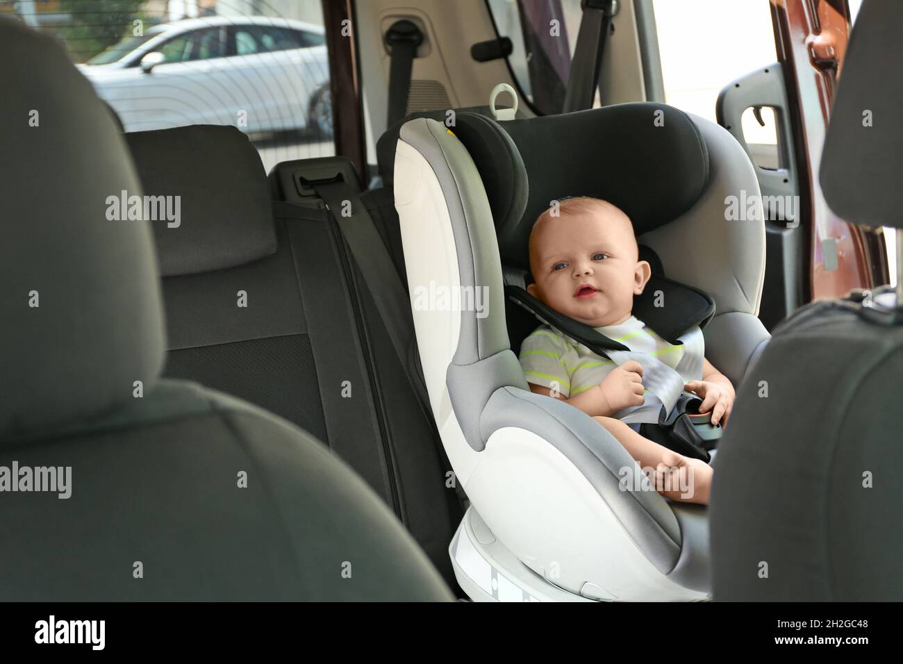 Little baby in child safety seat inside of car Stock Photo - Alamy