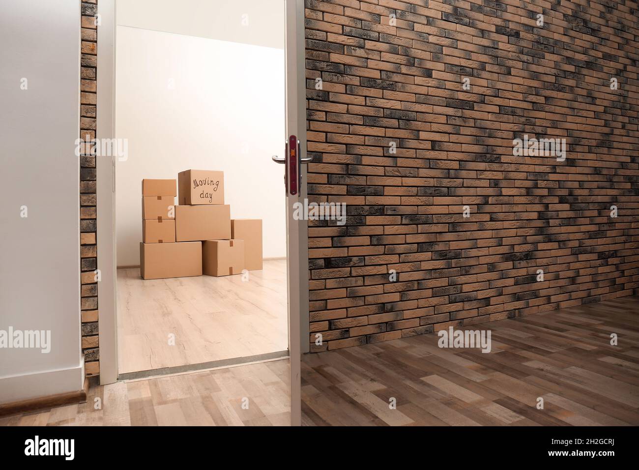 Pile of moving boxes in empty room Stock Photo - Alamy