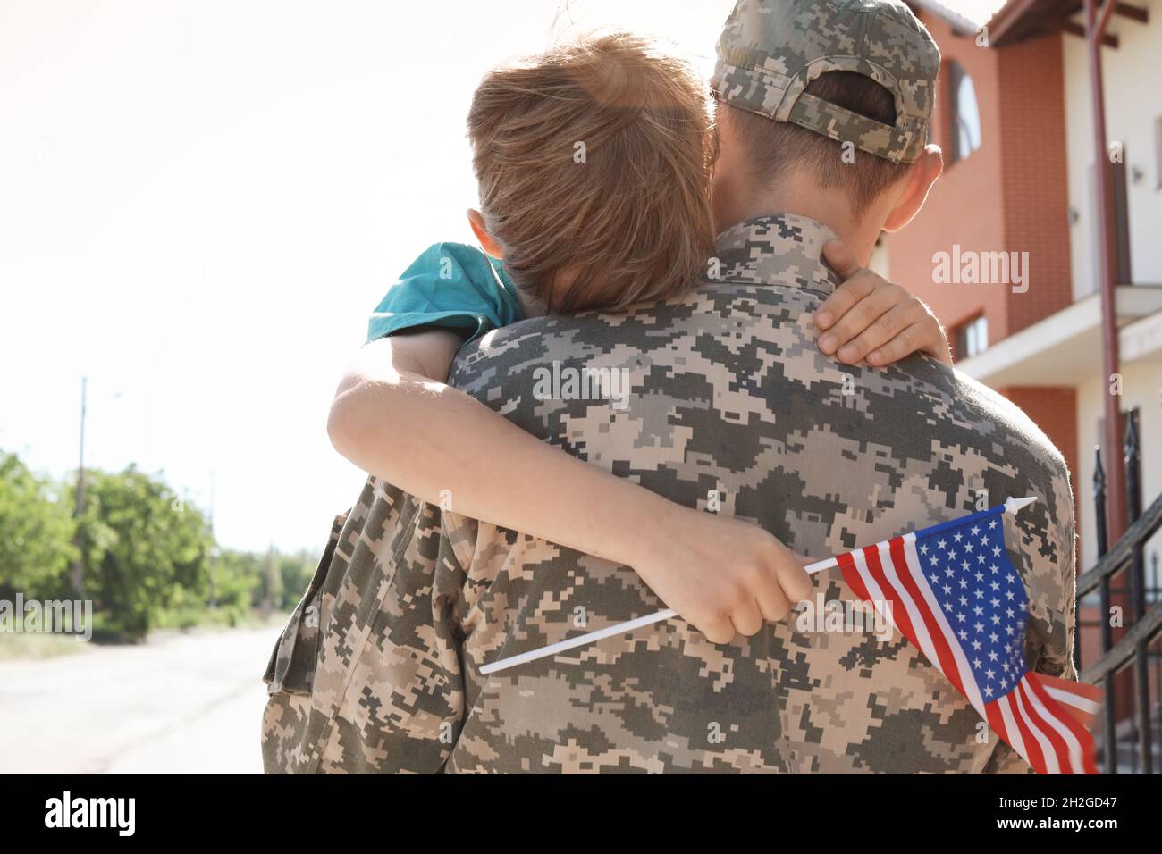 American soldier hugging with his son outdoors. Military service Stock ...