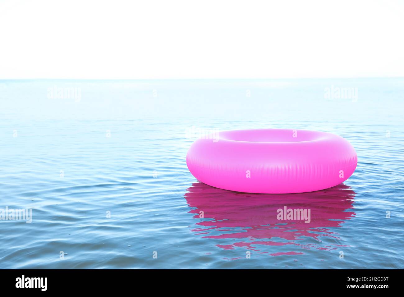 Inflatable ring floating on sea water. Summer vacation Stock Photo - Alamy