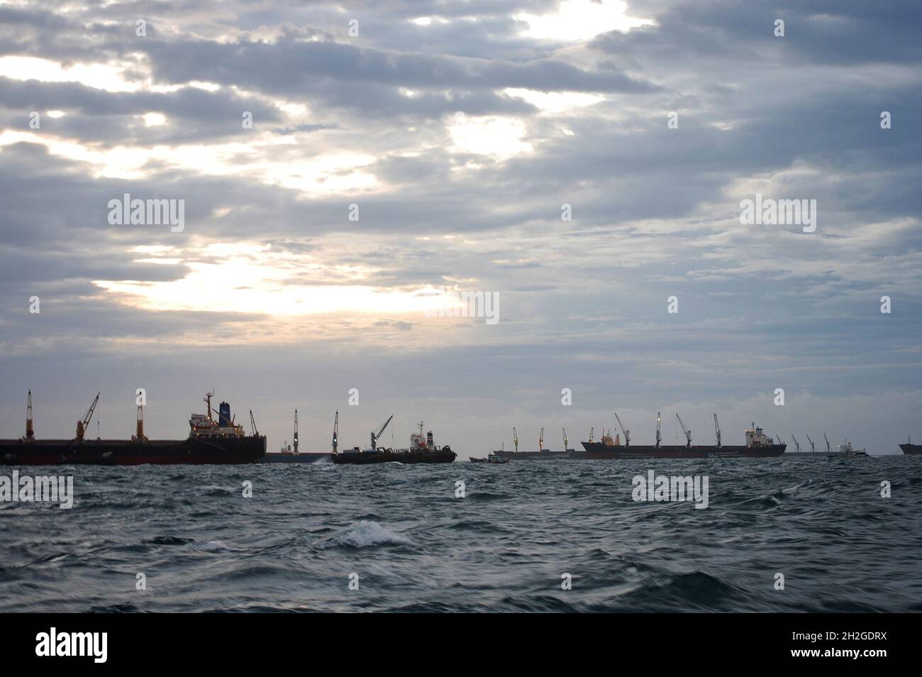 Freighter cargo ship floating in sea ocean wait queue transfer goods ...