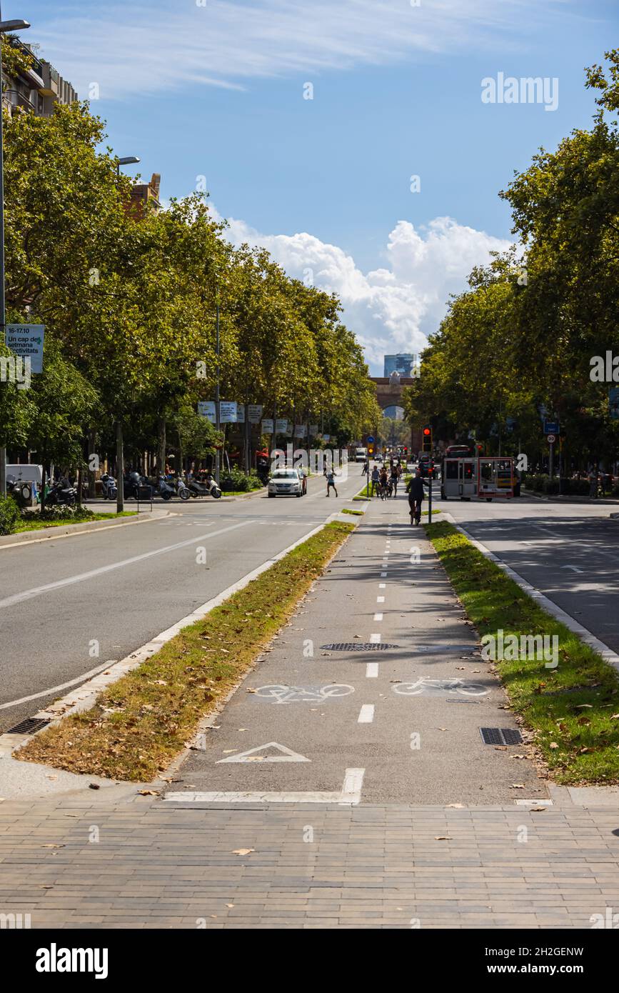 Barcelona, Spain - September 20, 2021: Bicycle lane on avenue Sant Joan. Cityscape with cyclists ...