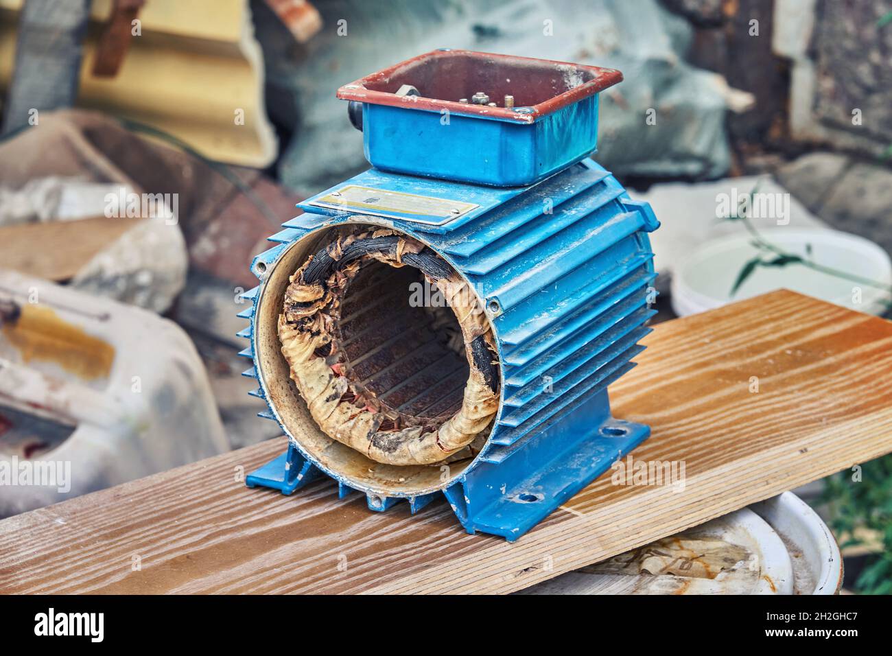 Burnt out electric engine with light blue metal case stands on long ...