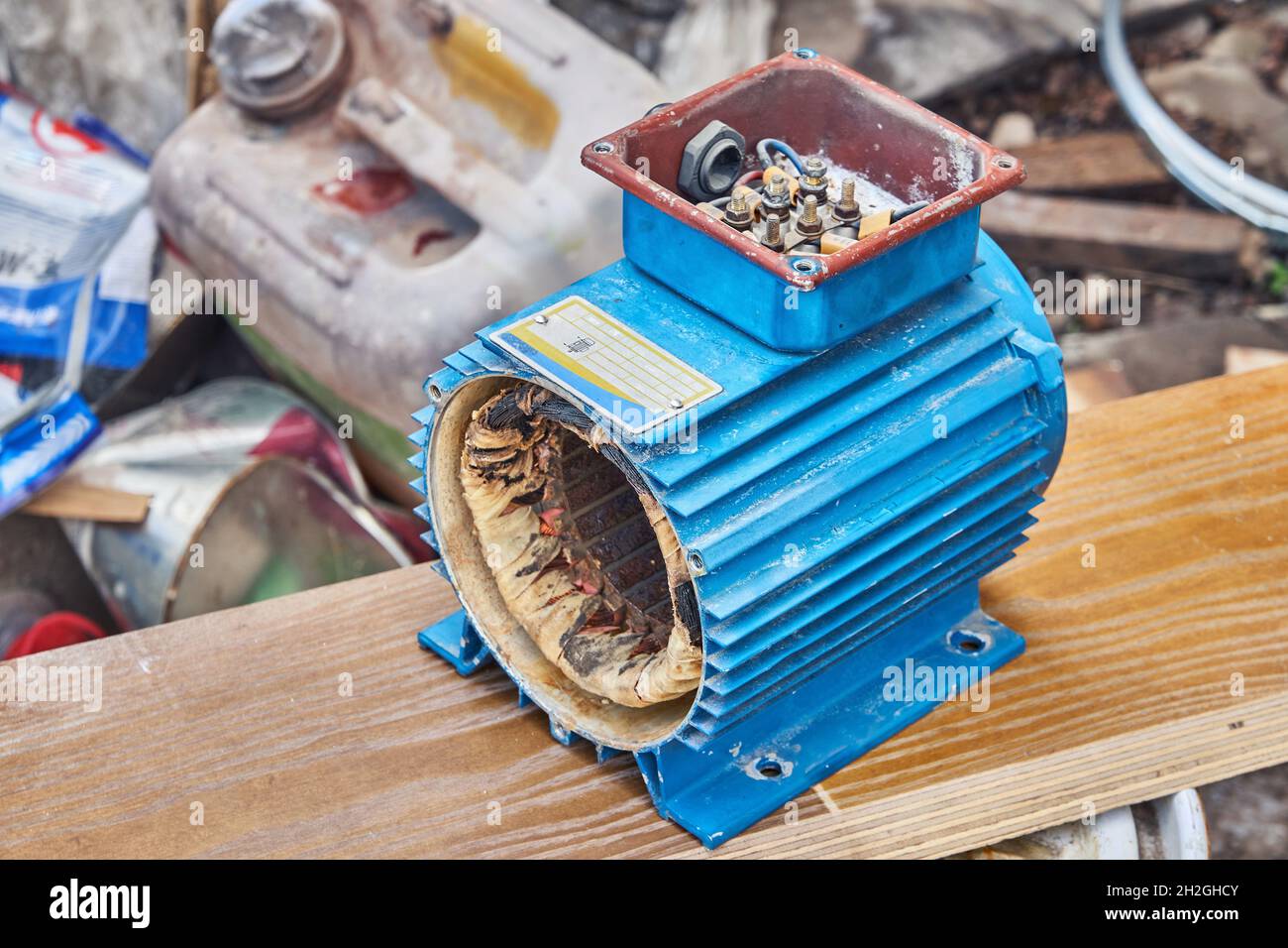 Burnt out electric engine with light blue metal case stands on long ...