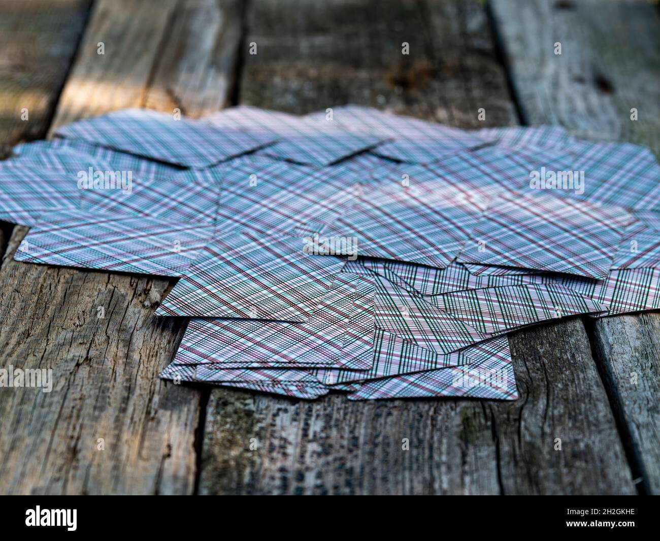 A deck of playing cards on a wooden table. A deck of playing cards ...