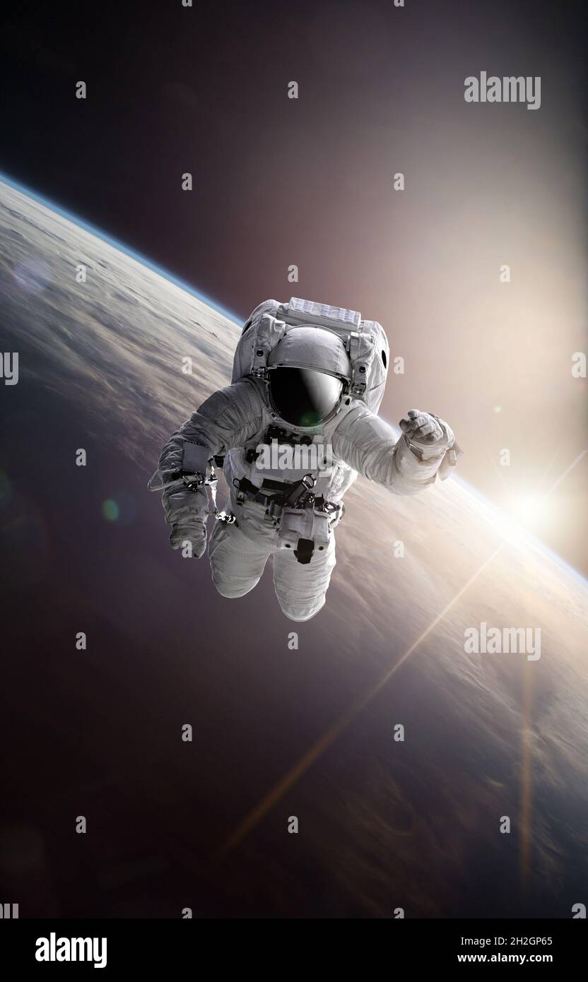 Astronaut in outer space over the planet Earth.Stars provide the ...