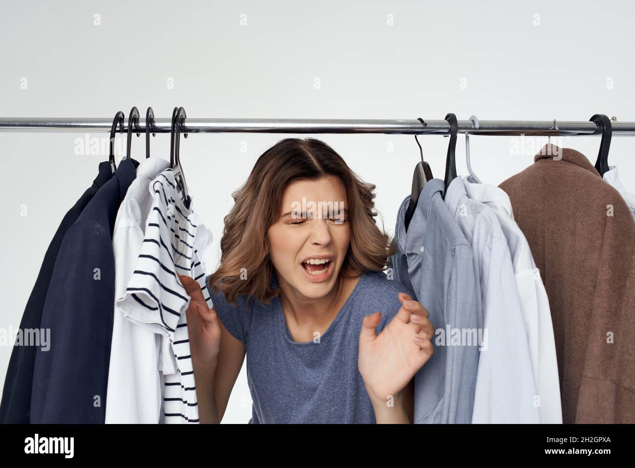 woman clothes fitting modern style light background Stock Photo - Alamy