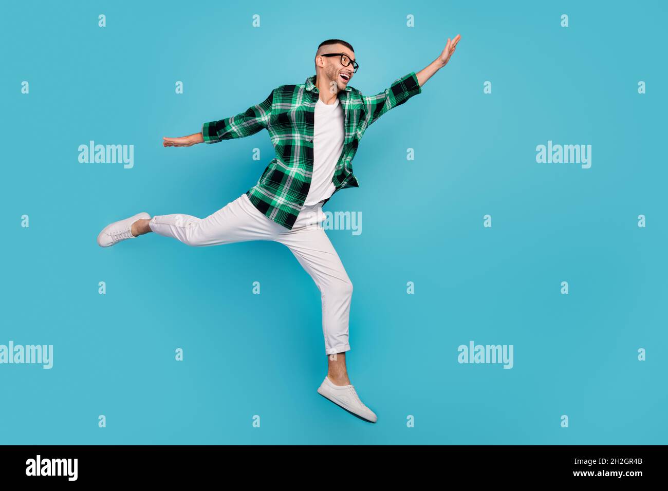 Full length photo of happy young amazed man look empty space jump up ...